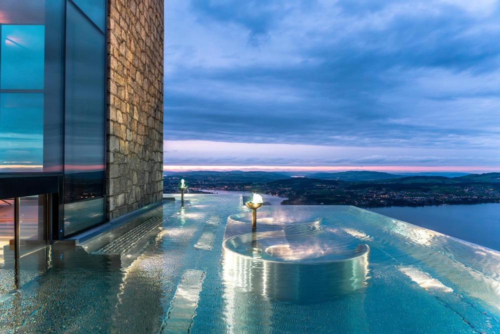 Infinity pool overlooking Lake Lucerne at Bürgenstock Hotel, Switzerland.